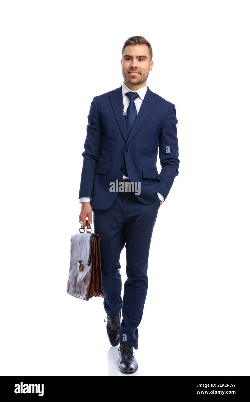 handsome bearded man in navy blue suit looking up, holding hand in ...