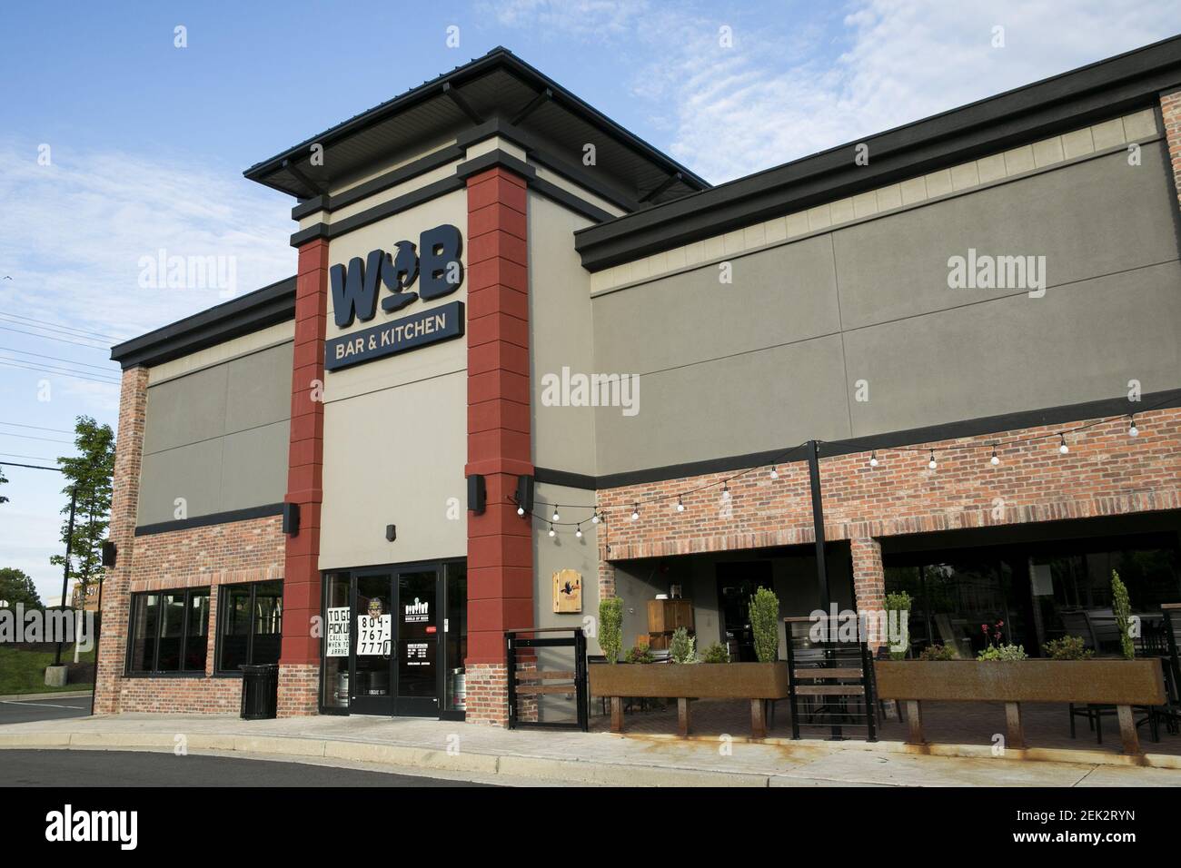 A logo sign outside of a World of Beer (WOB) restaurant location in ...
