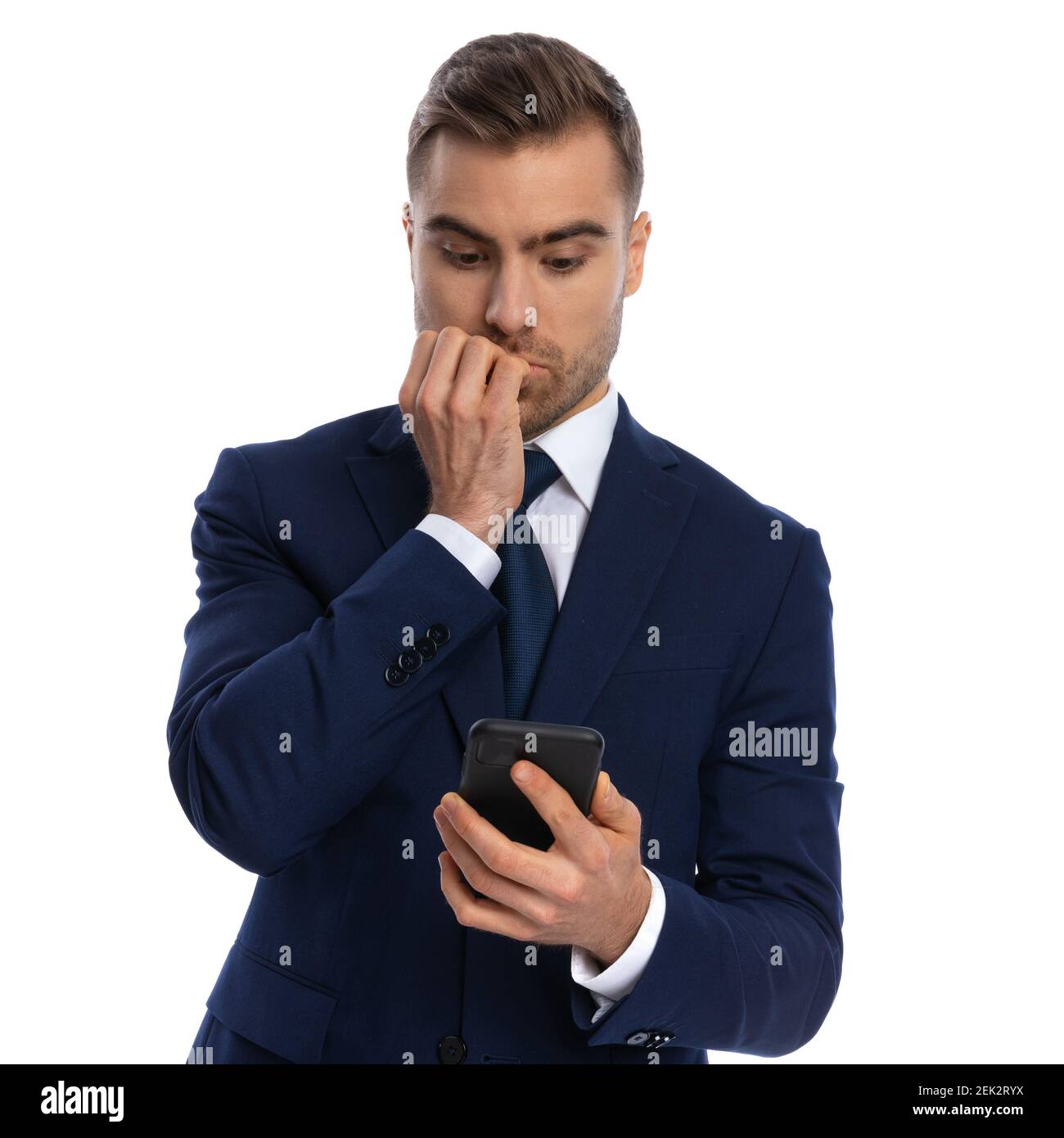 portrait of scared guy in elegant navy blue suit looking at phone ...