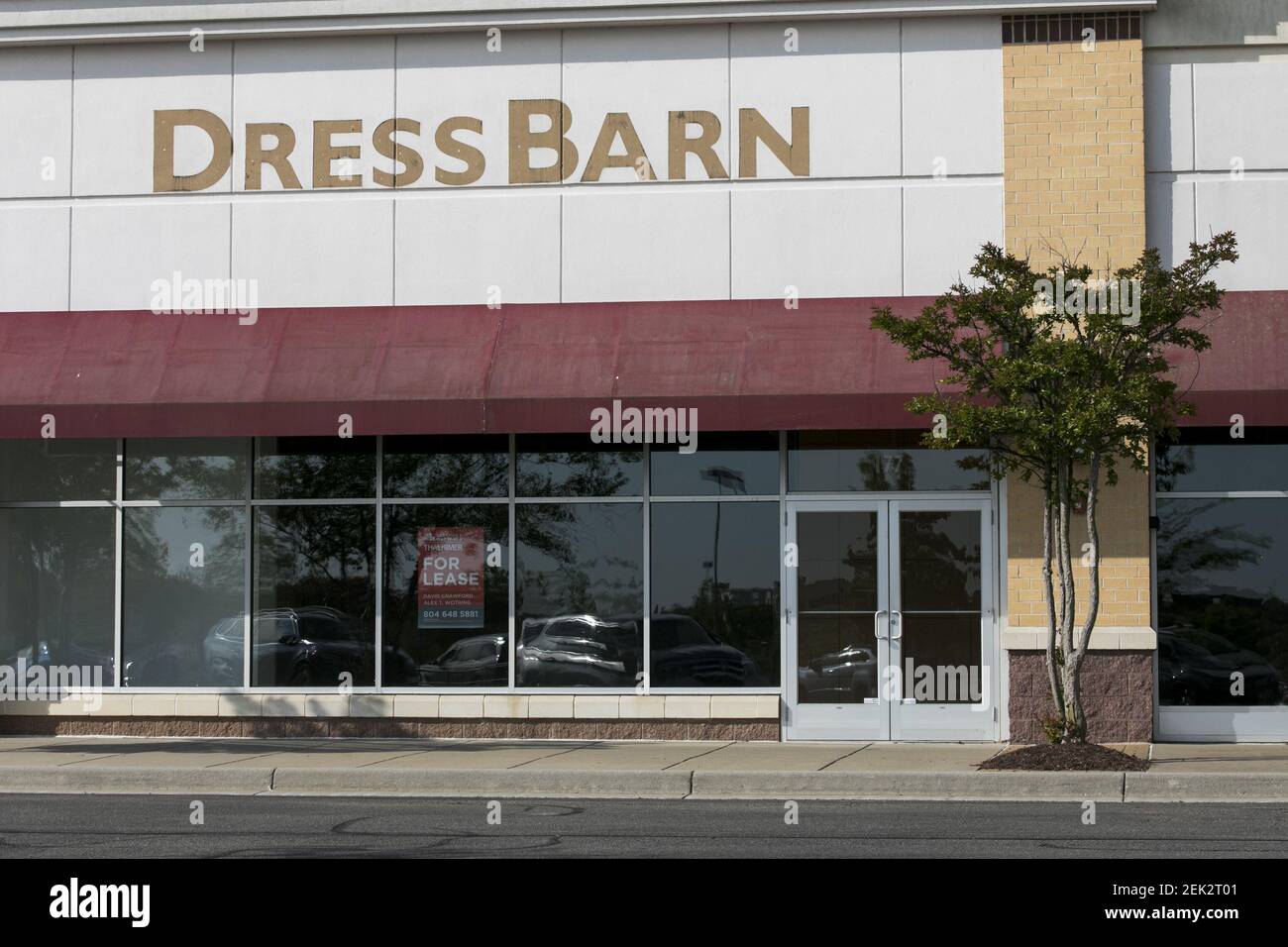 The outline of a logo sign outside of a closed and abandoned Dressbarn ...