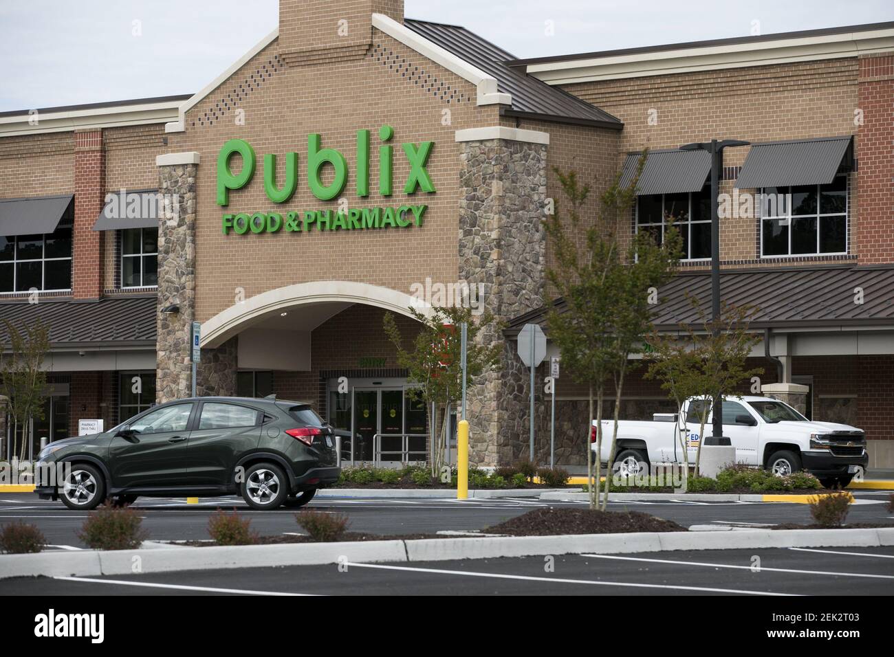 A logo sign outside of a Publix Super Markets retail grocery store ...