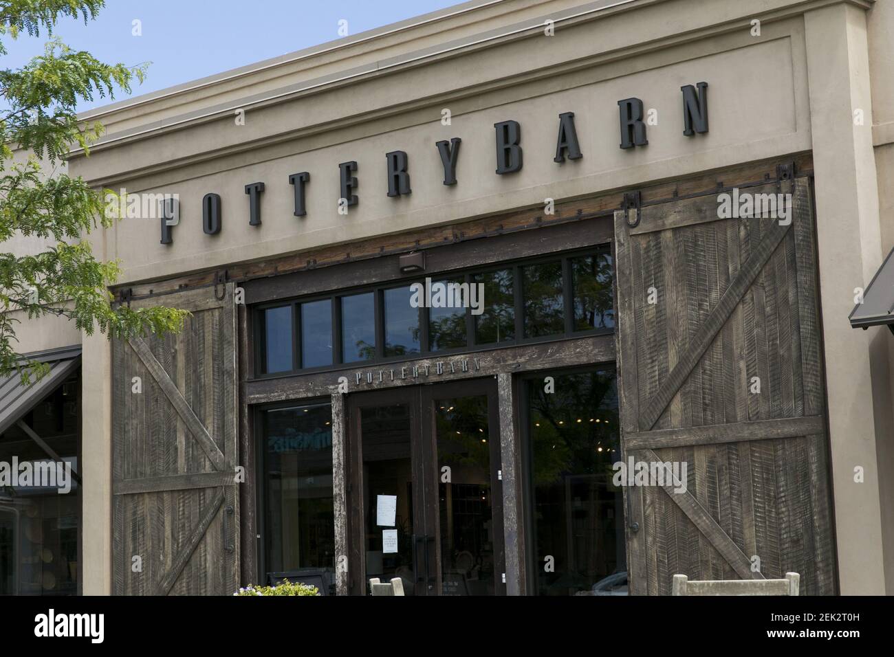 A logo sign outside of a Pottery Barn retail store location in ...