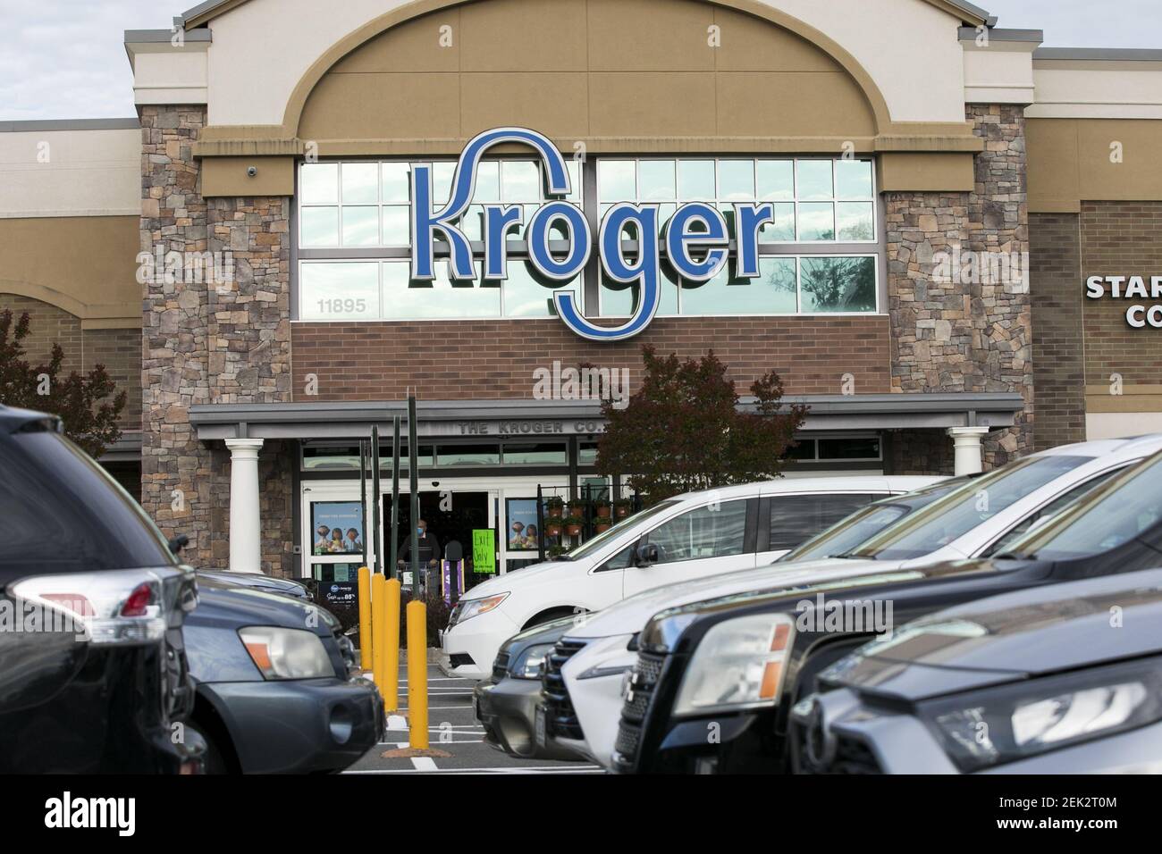 A logo sign outside of a Kroger retail grocery store location in ...