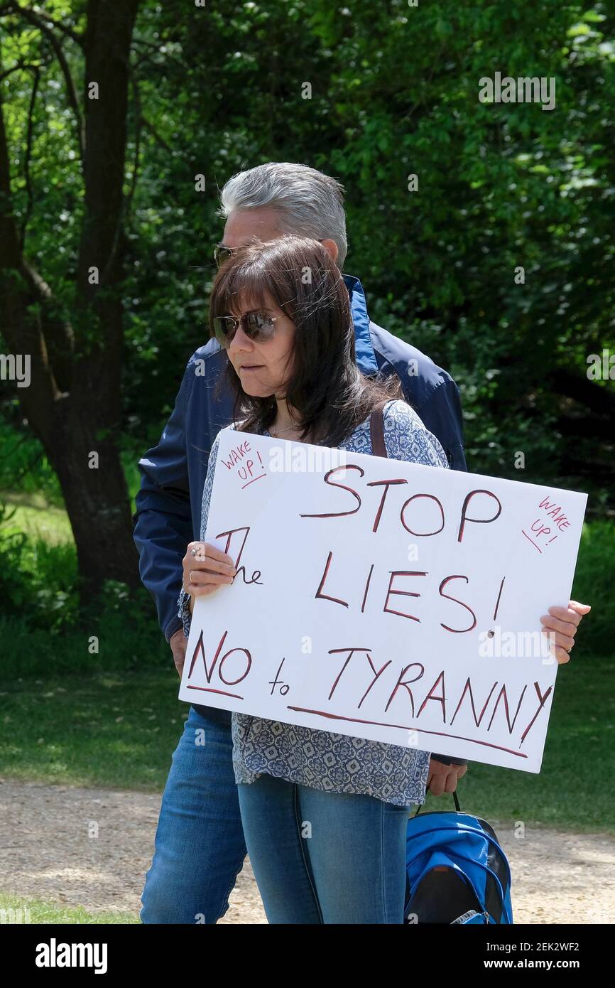 A protester holding a placard saying, Stop The Lies! No to Tyranny ...