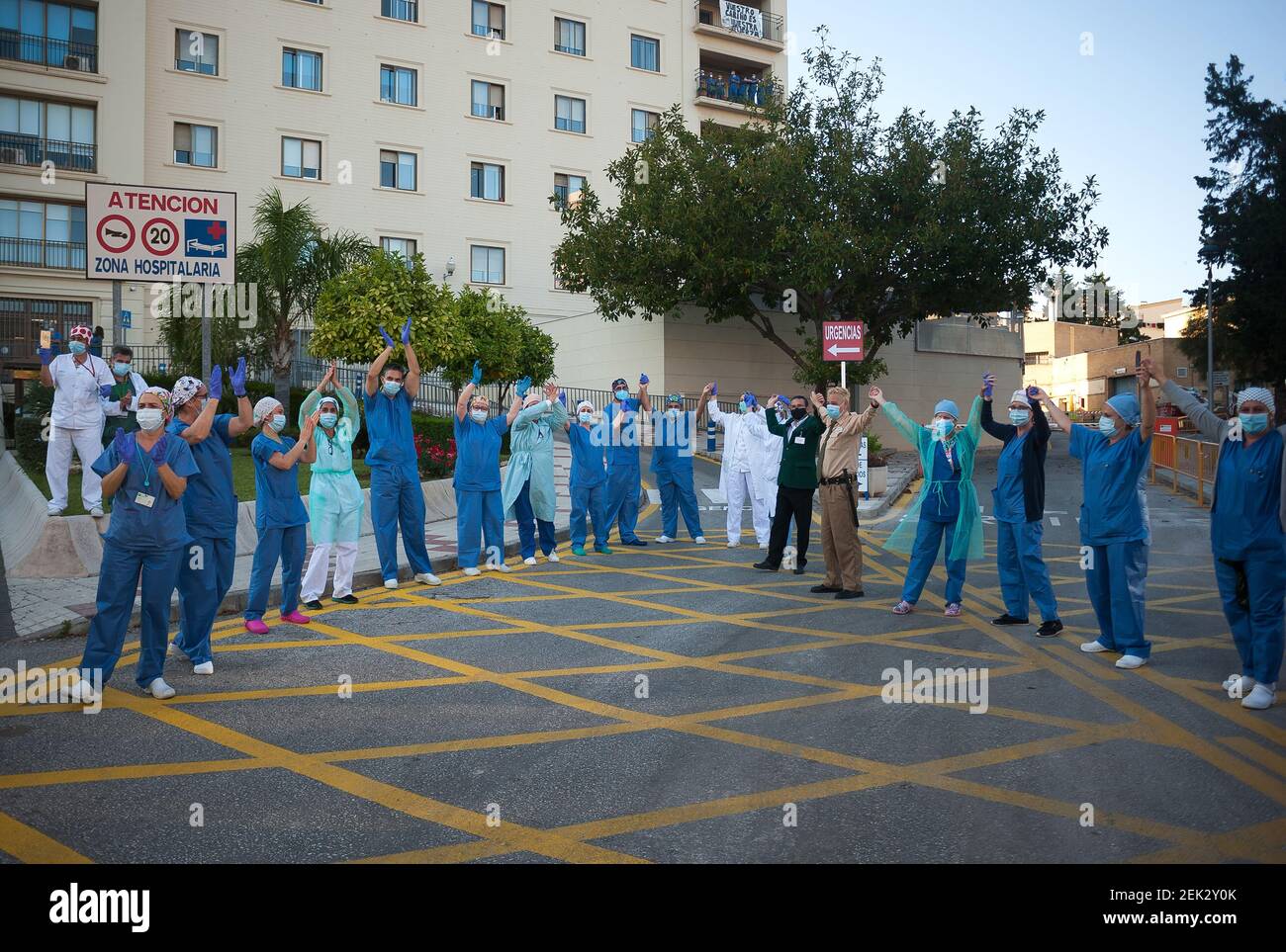 Healthcare workers are seen applauding outside the Regional Hospital ...
