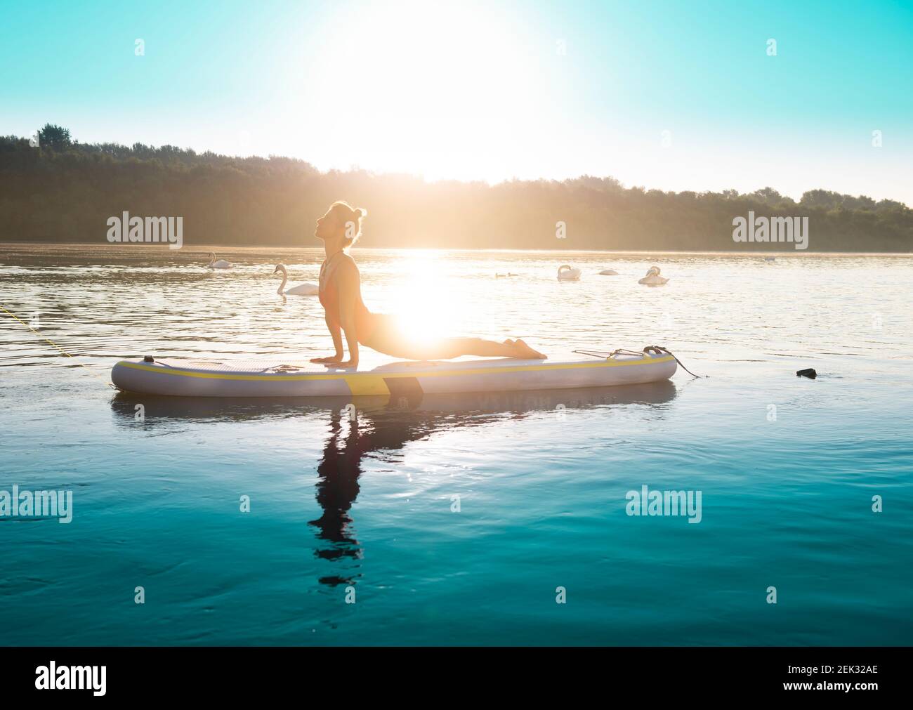 Yoga meditation on paddleboard at sunset hi-res stock photography and ...