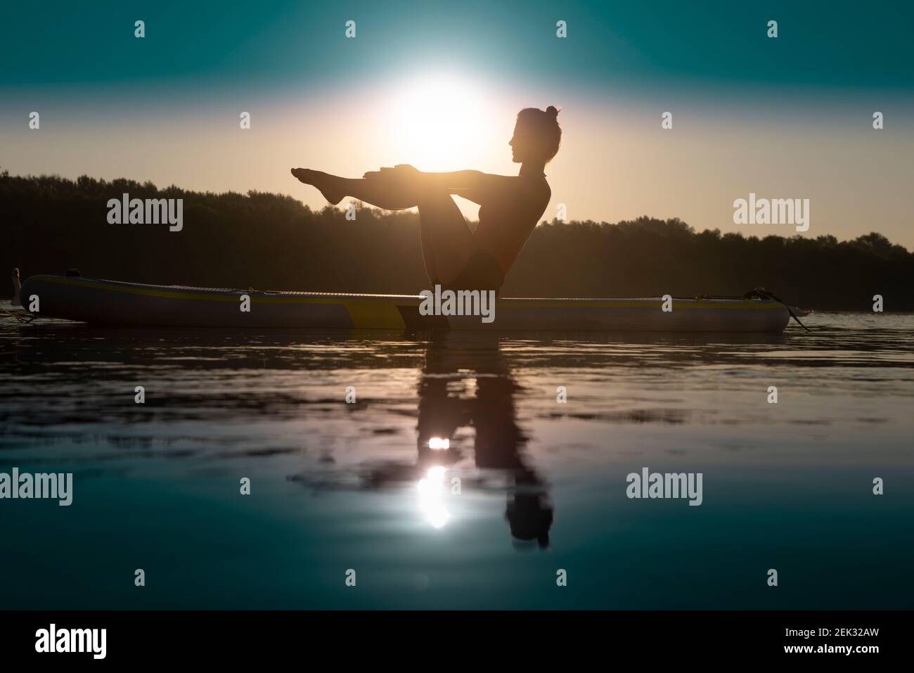 Yoga meditation on paddleboard at sunset hi-res stock photography and ...