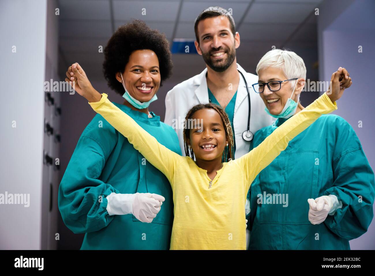 Team of experienced highly qualified doctors with child patient after a ...