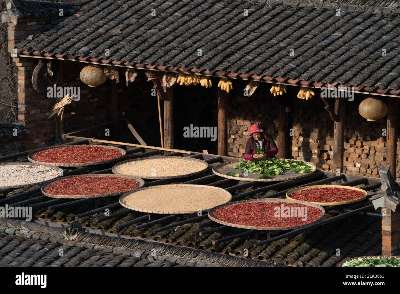 In this undated photo, various kinds of food are aired on the roof in ...