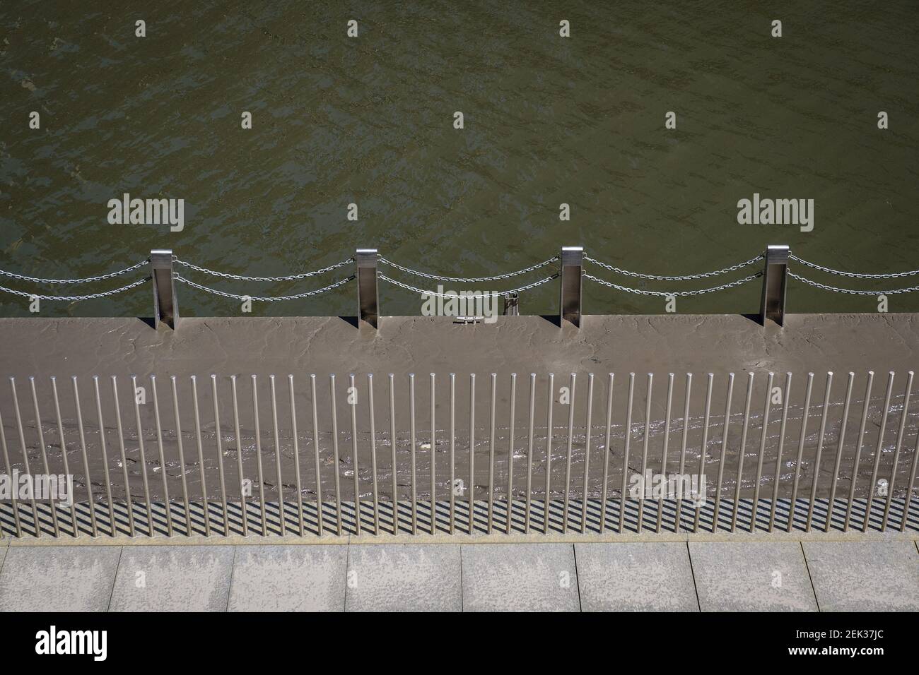 Muddy footprints can be seen on a pedestrian walkway a day after record ...