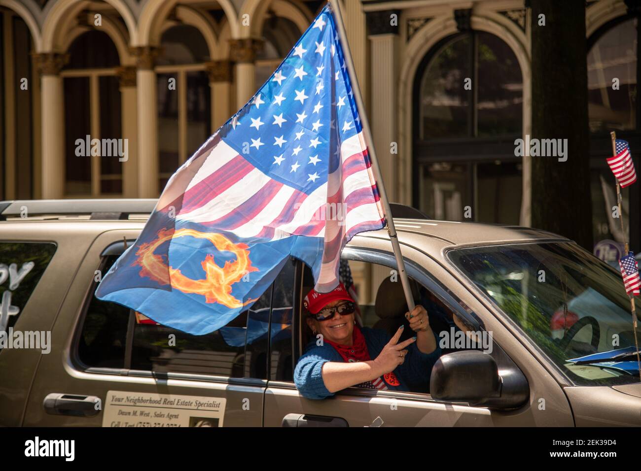 A woman waves an American flag adapted to reflect QAnon out of the ...