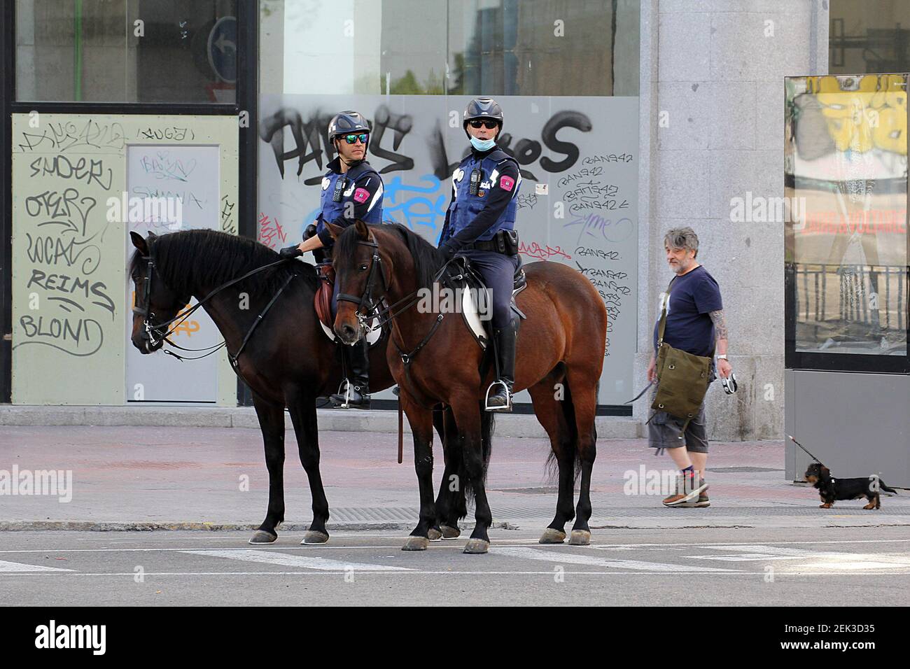 Two Madrid municipal police officers watch during the health crisis due ...