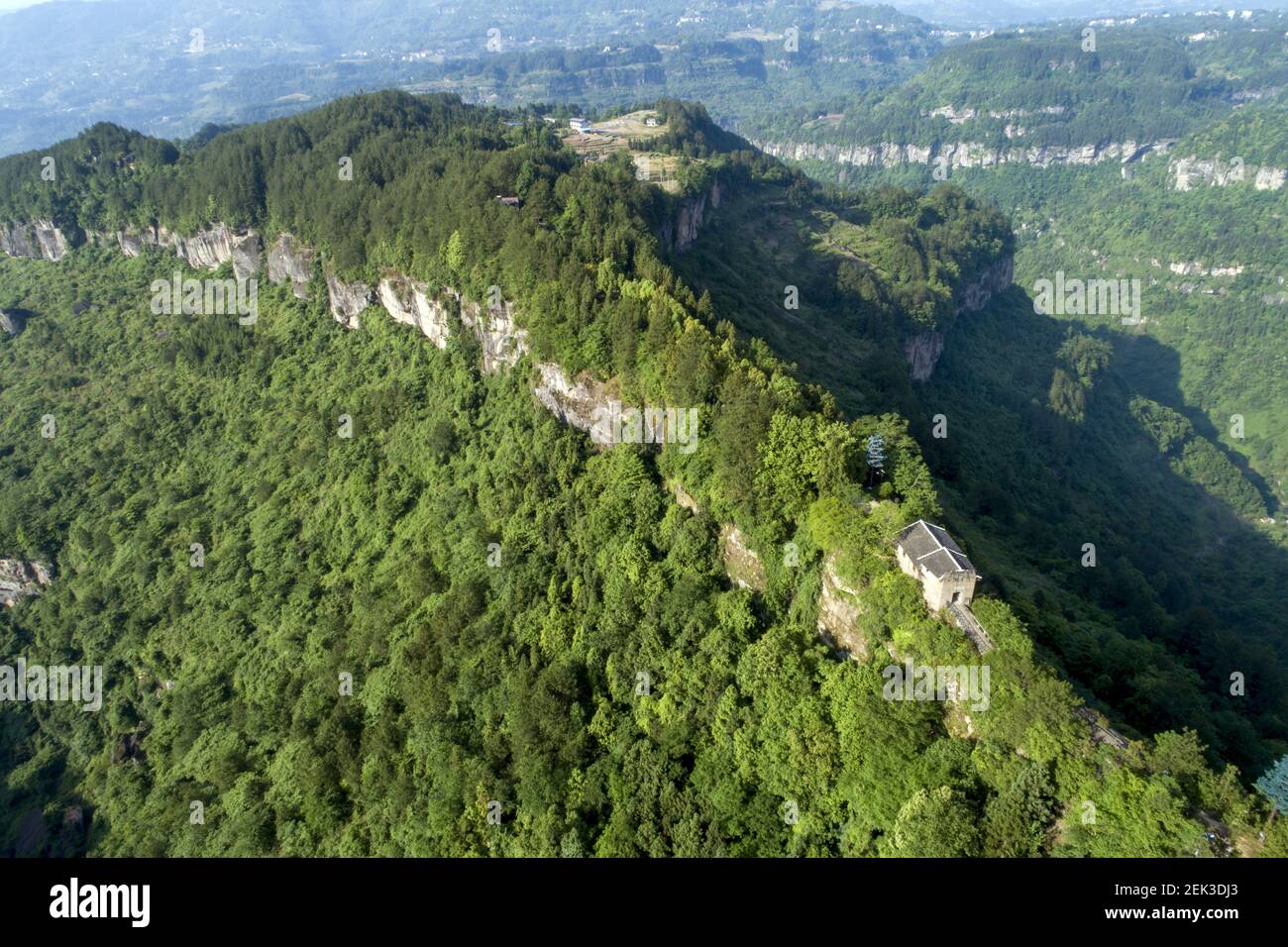 Aerial view of Yumu Village, a Tujia village surrounded by cliffs in ...