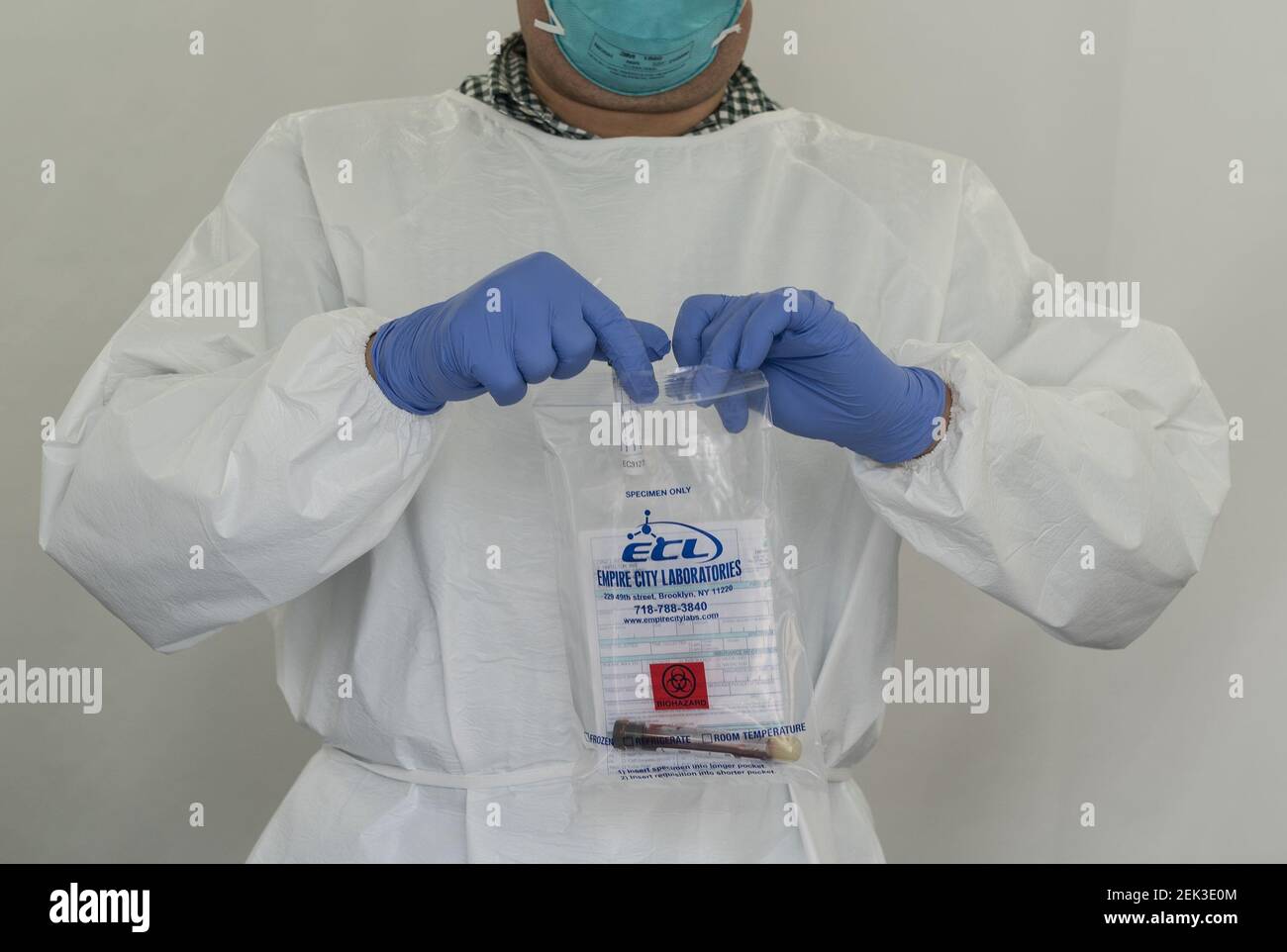Laboratory technician holds bag with antibody & swab tests tubes for ...