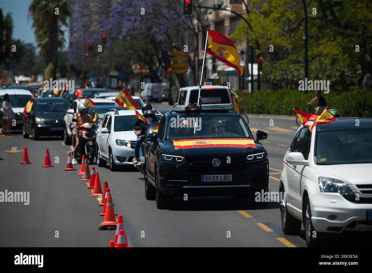 Cars decorated with the Spanish flags drive on the street during the ...