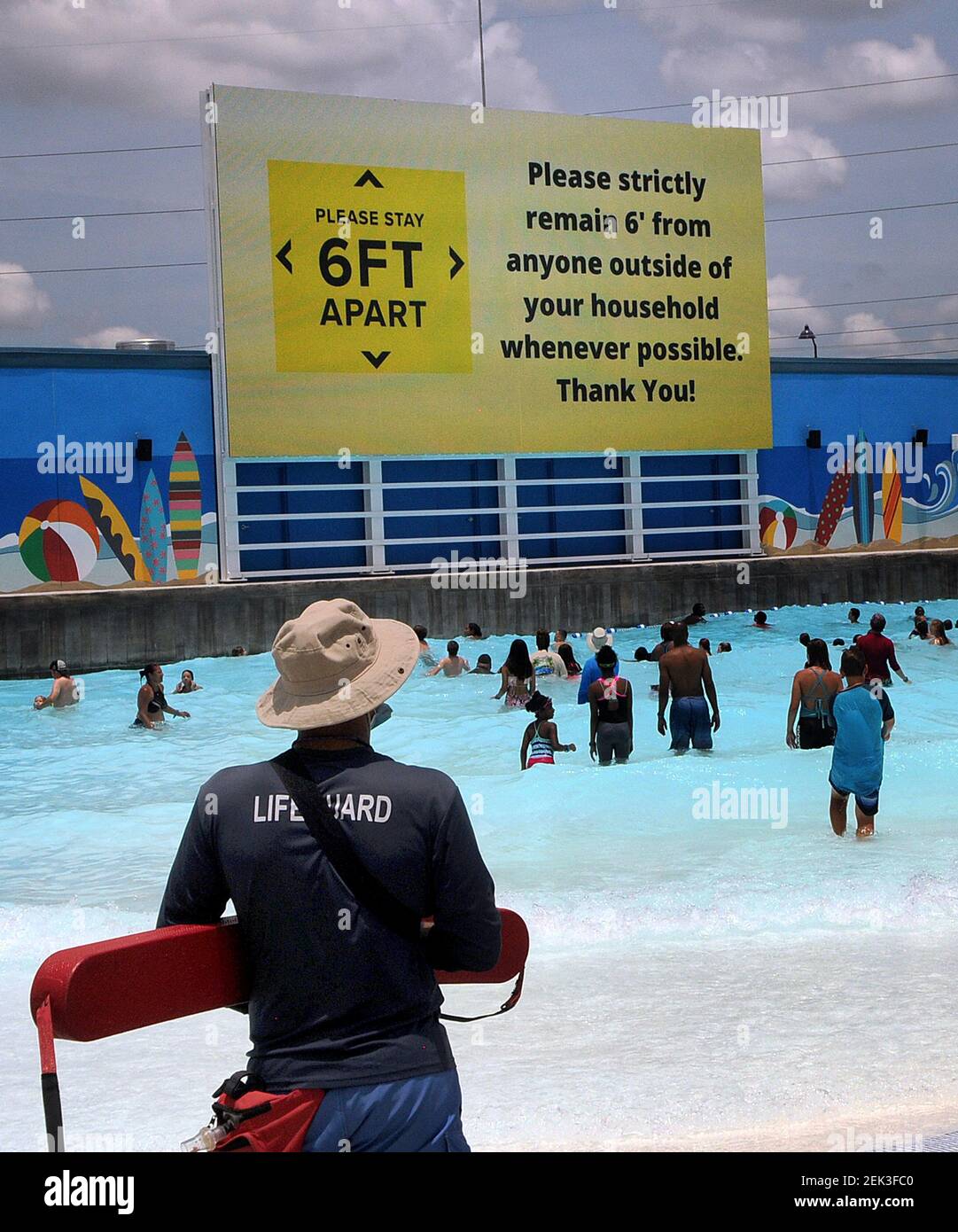 A social distancing notice is displayed at the wave pool at Island H2O ...
