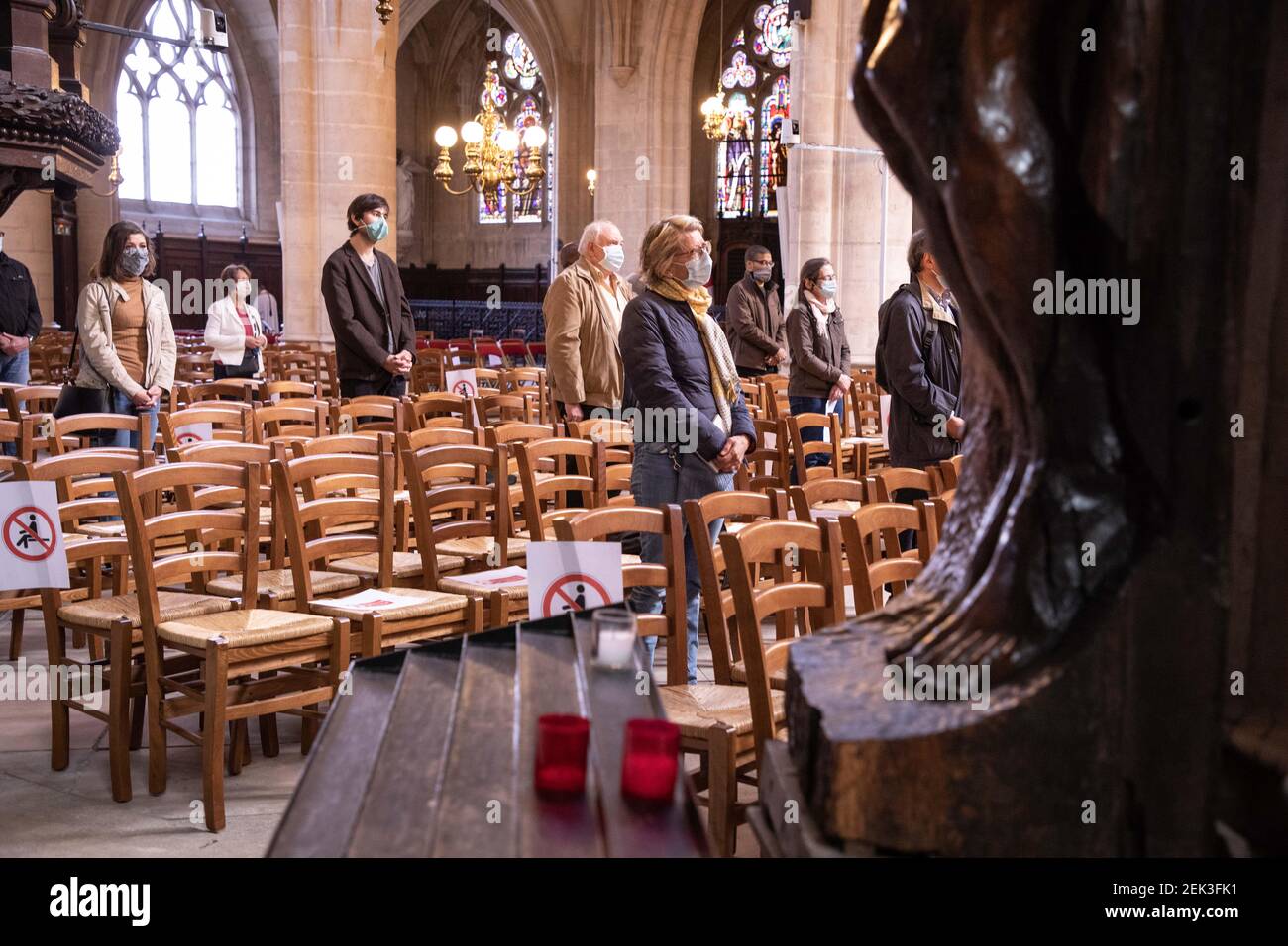 A view of Catholics wearing face masks and keeping social distance ...