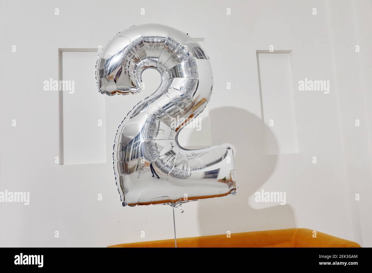 Silver foil balloon in shape of number two during birthday celebration ...