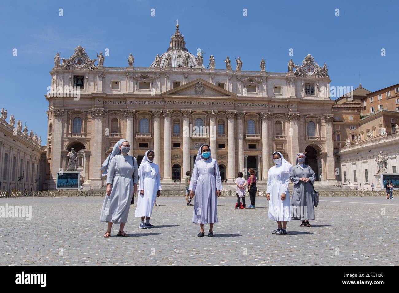 Nuns take a picture in front of St. Peter's Basilica, after the end of ...