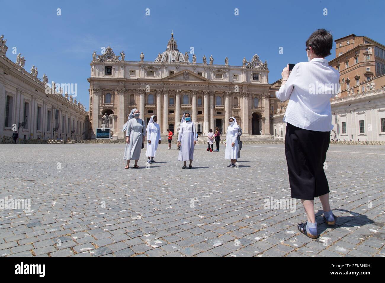 Nuns take a picture in front of St. Peter's Basilica, after the end of ...