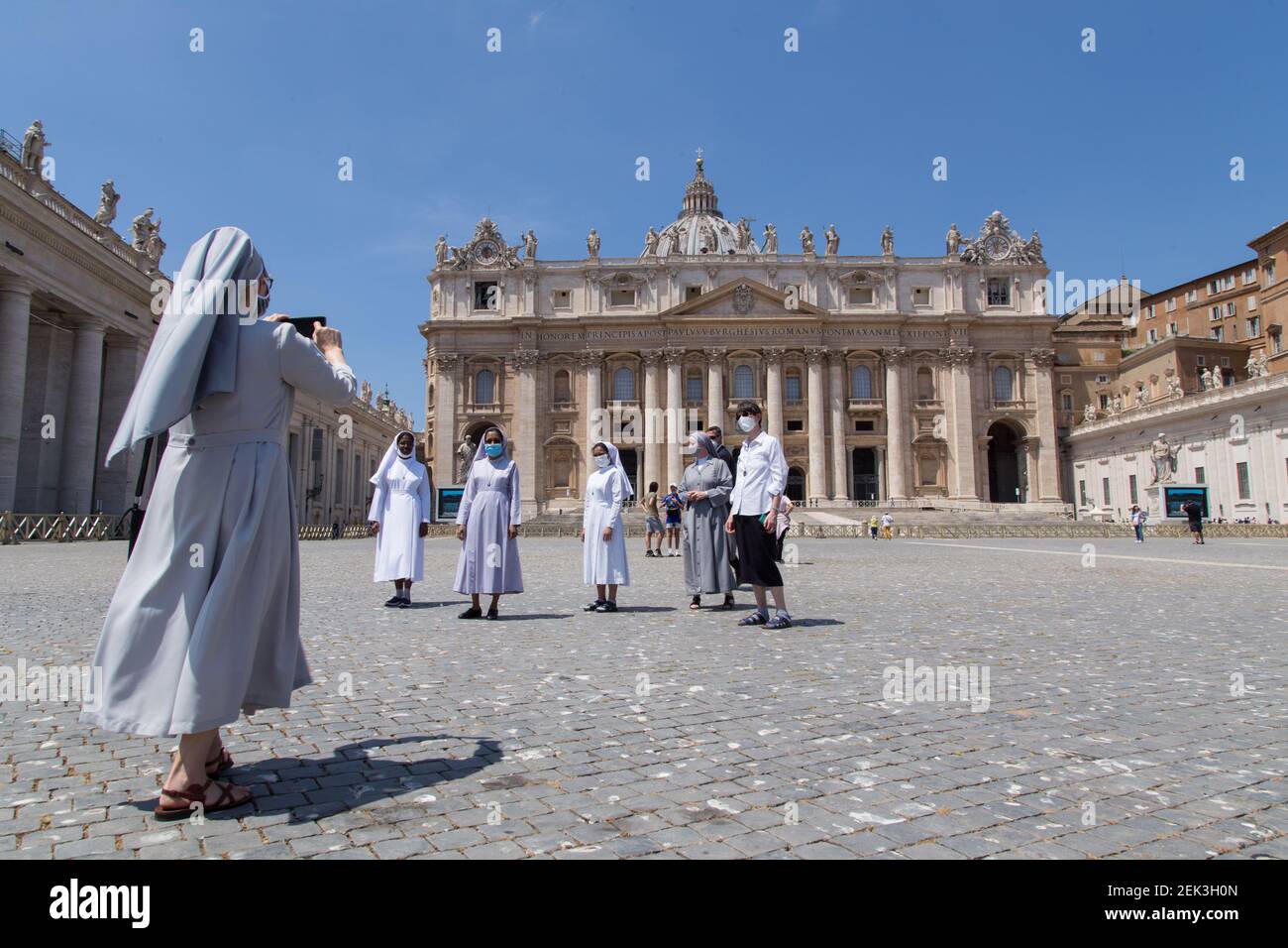Nuns take a picture in front of St. Peter's Basilica, after the end of ...
