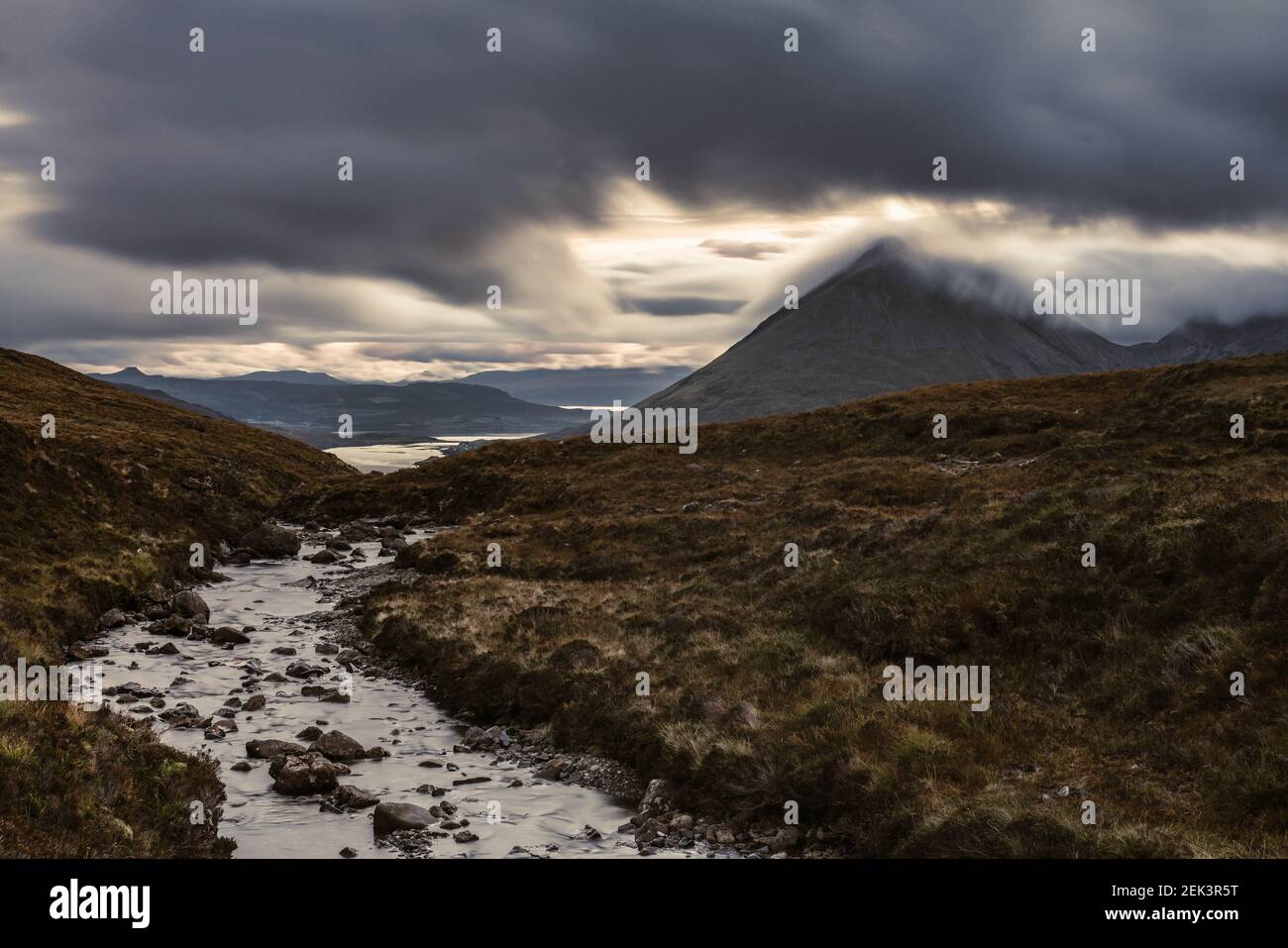Scenic view of a highland's landscape with mountains and a stream Stock ...