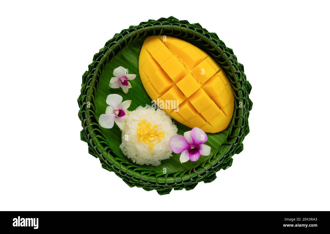 Thai dessert - mango sticky rice on banana leaf plate isolated on white ...