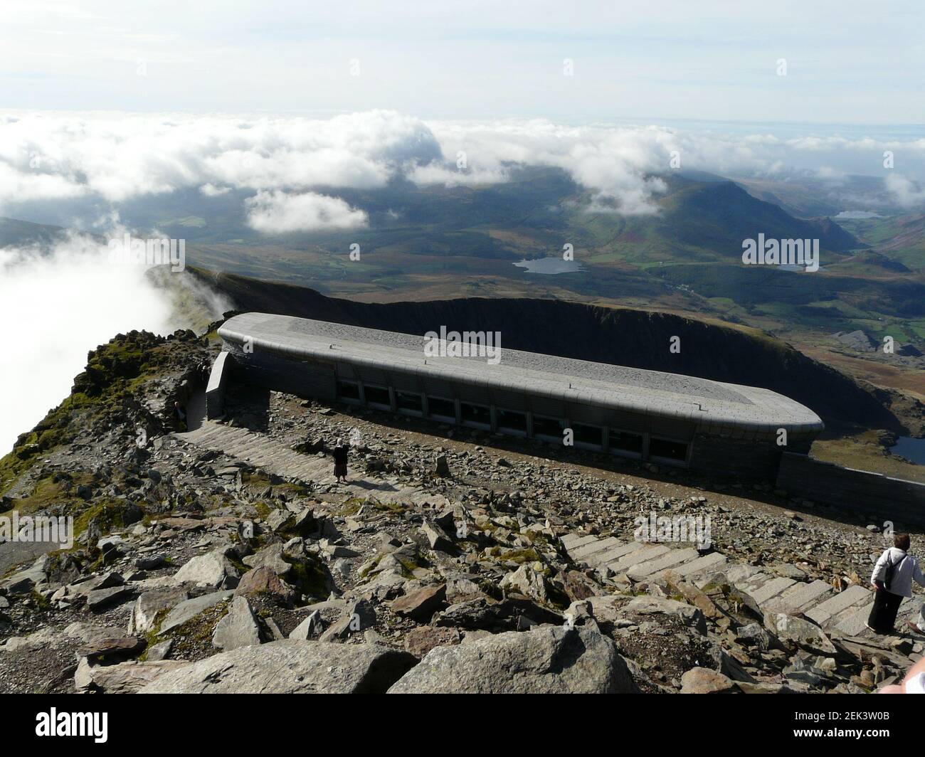 Aerial shot of a long building on the top of a mountain and stairs ...