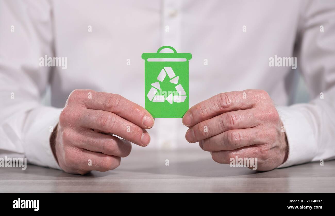 Man holding a recycling bin; Concept of recycling Stock Photo - Alamy