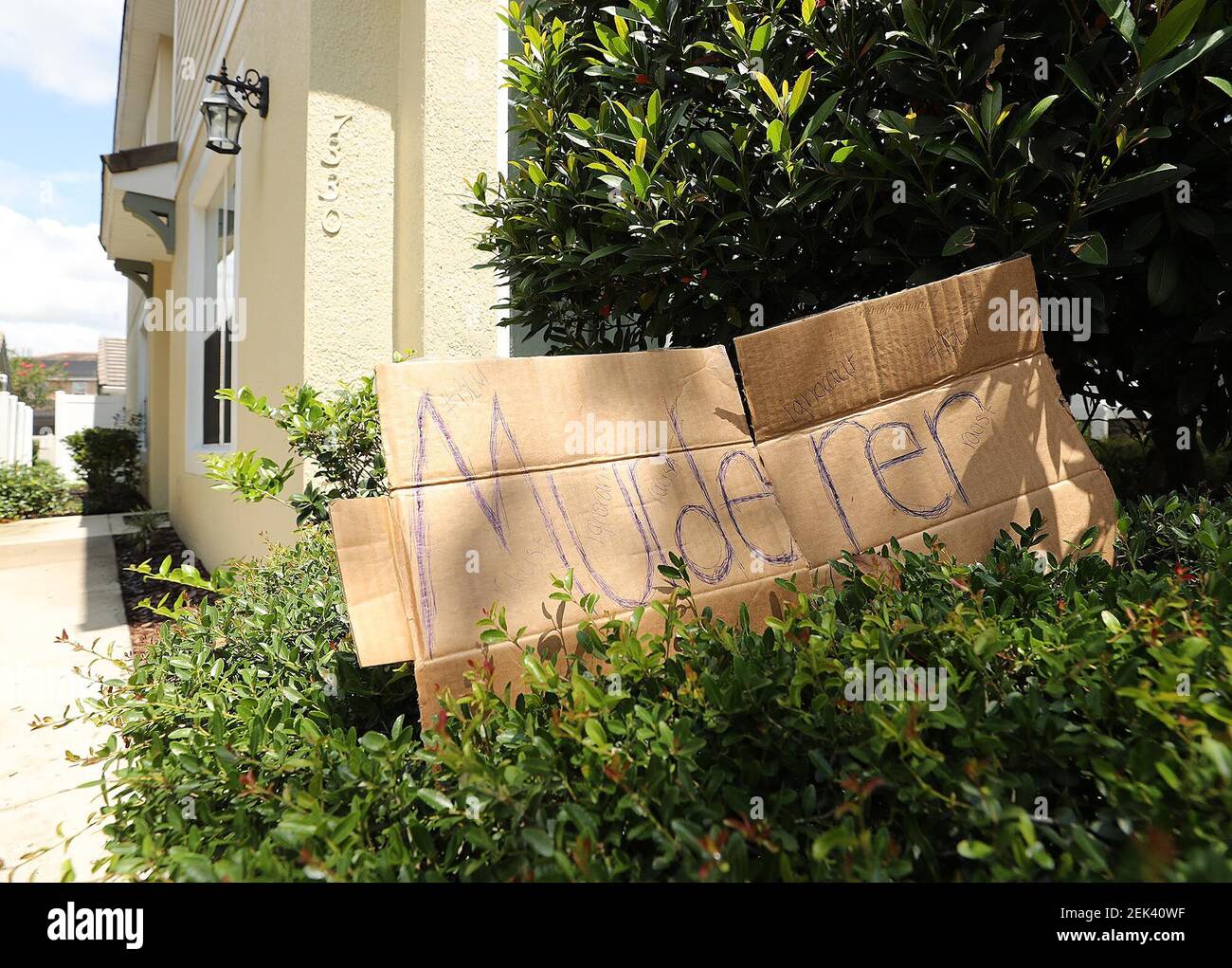 A sign reading “Murderer” is placed on Friday, May 29, 2020, outside a ...