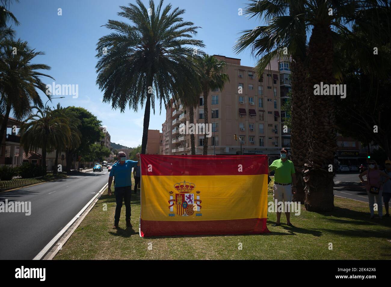 Supporters are seen holding a large Spanish flag during the protest in ...