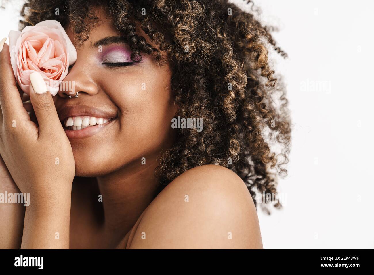 Happy african american girl with rose smiling at camera isolated over ...
