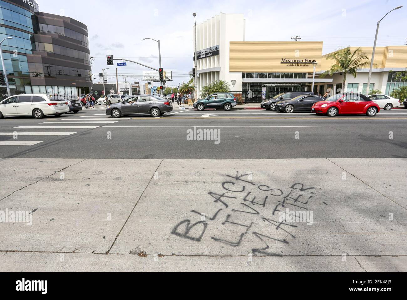 A "Black Lives Matter" graffiti tag remains on display on a sidewalk at ...