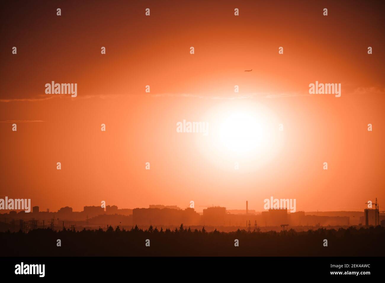 Big red sun over city buildings at sunset, top view Stock Photo - Alamy