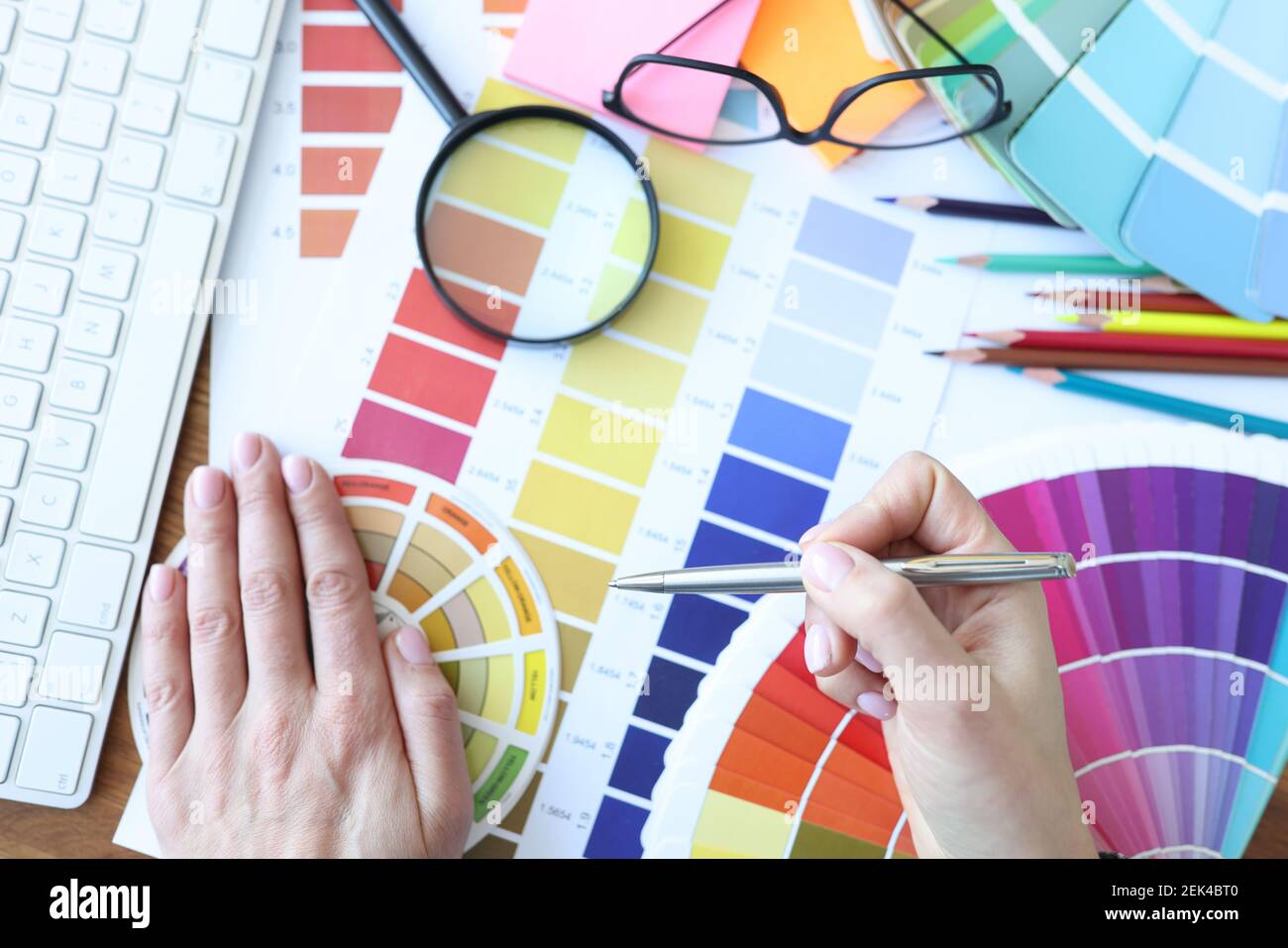 Designer develops color combinations on desktop closeup Stock Photo - Alamy