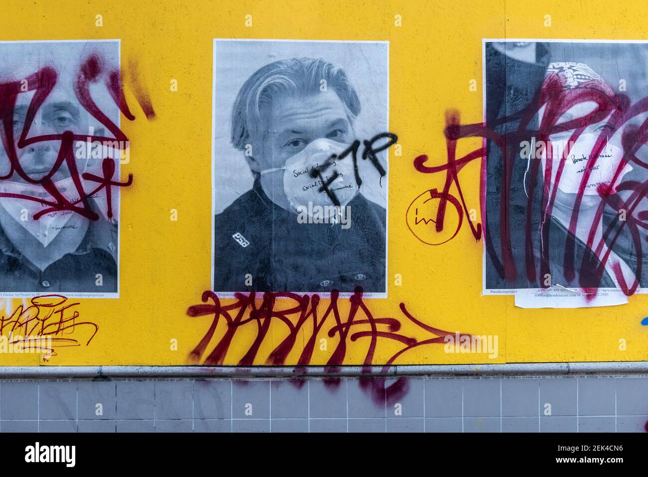 "FTP" graffiti is sprayed on a COVID-19 PSA featuring frontline workers ...