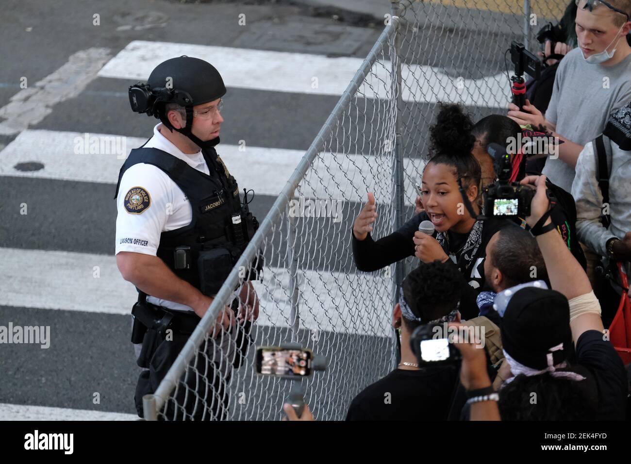 Protesters speak to a police liaison officer on the fourth day of ...