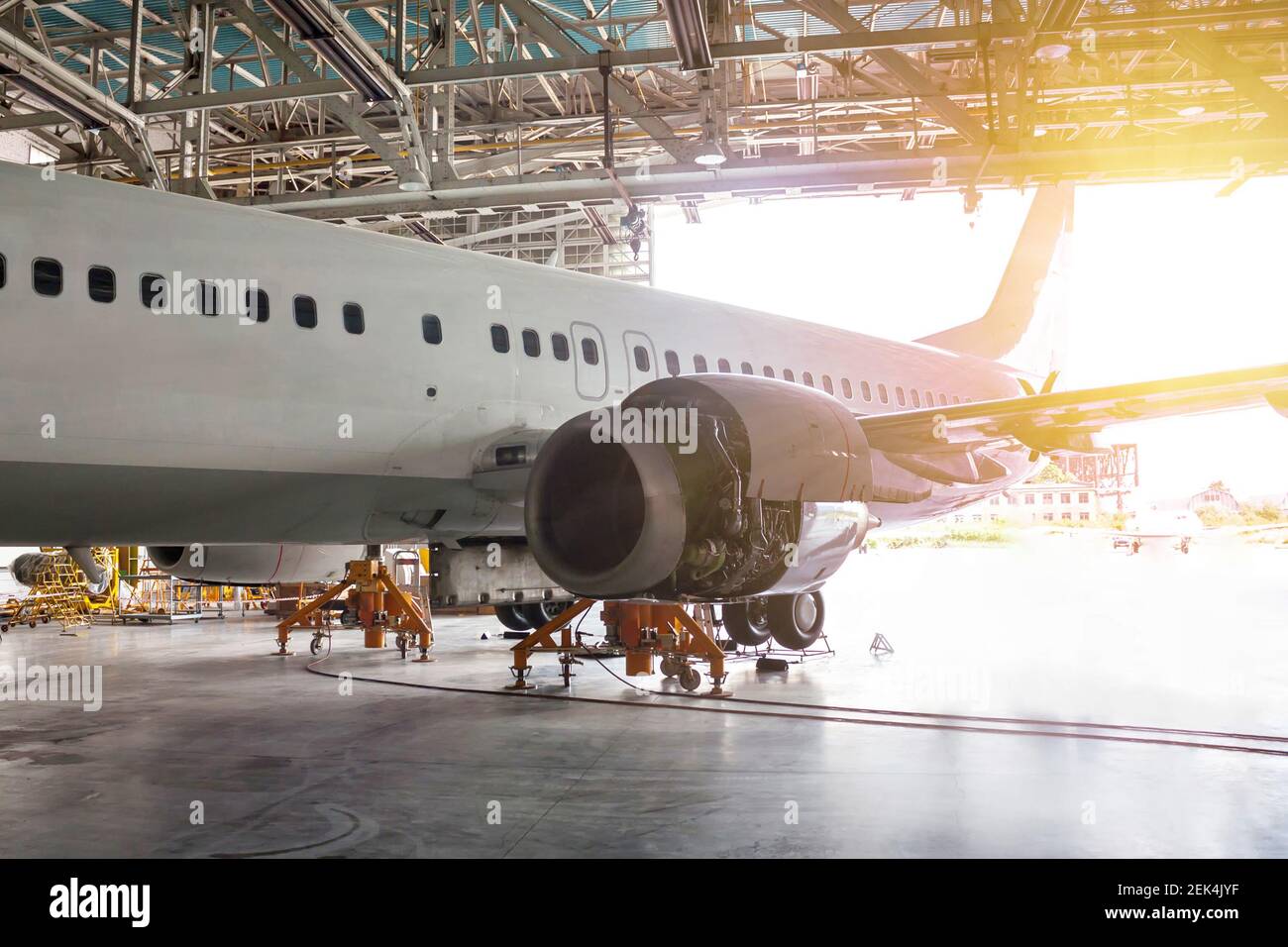 White passenger airliner under maintenance in the hangar. Repair of jet ...