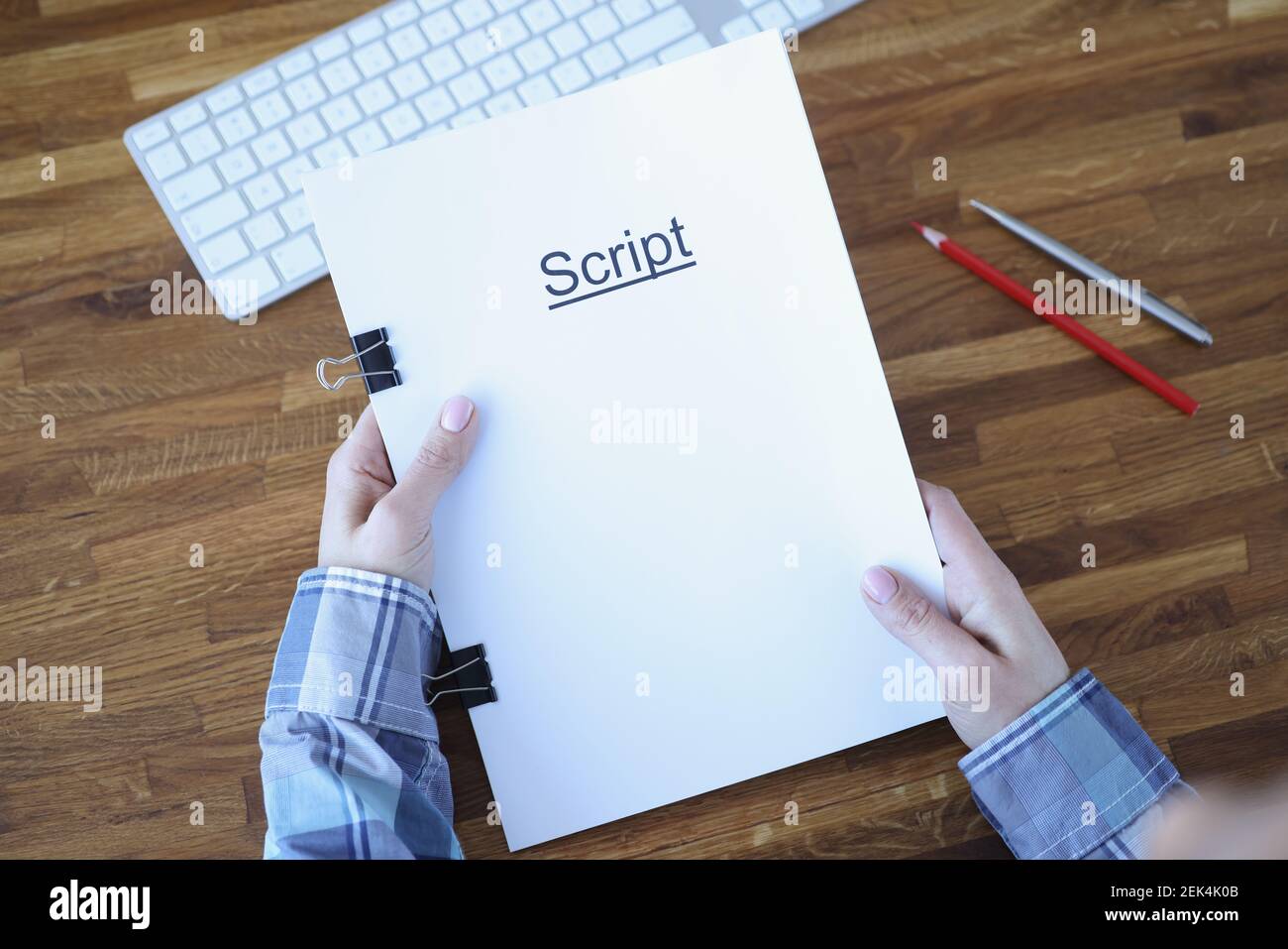 Screenwriter holds folder of documents labeled script Stock Photo - Alamy