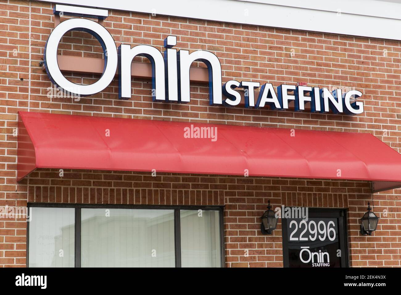 A logo sign outside of a facility occupied by Onin Staffing in Seaford ...