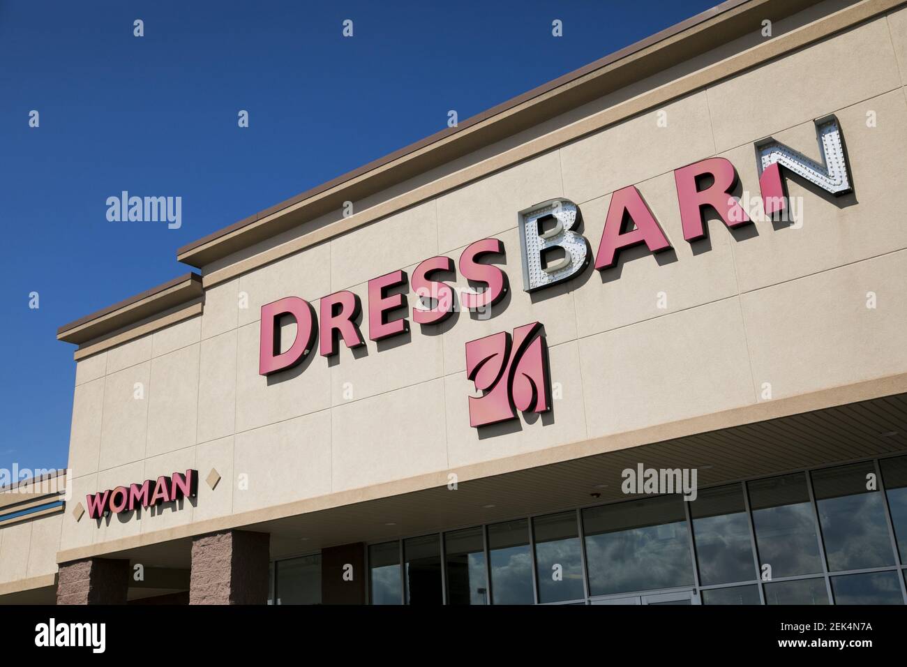A logo sign outside of a closed and abandoned Dressbarn retail store ...