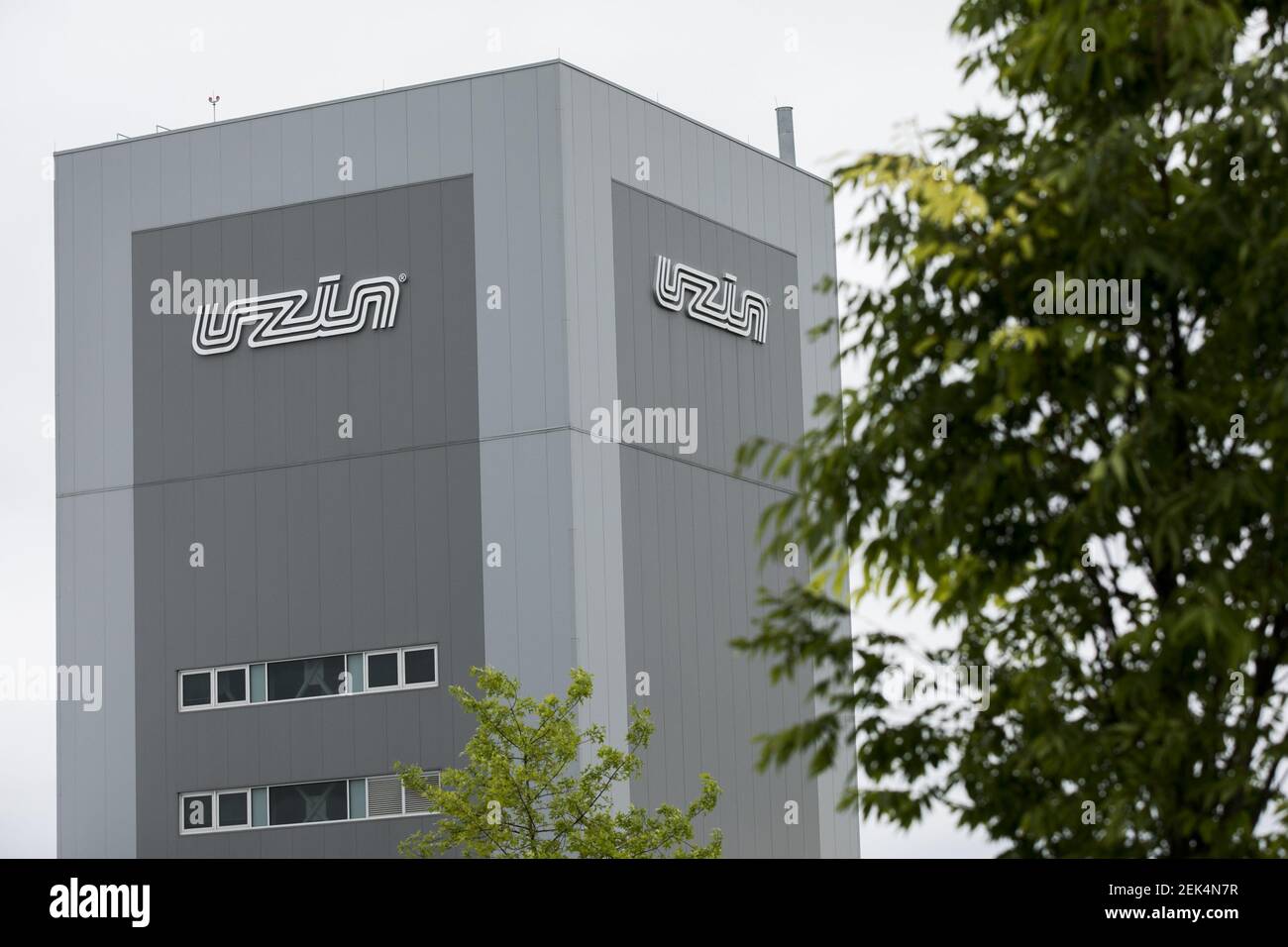A logo sign outside of a facility occupied by Uzin Utz in Dover ...