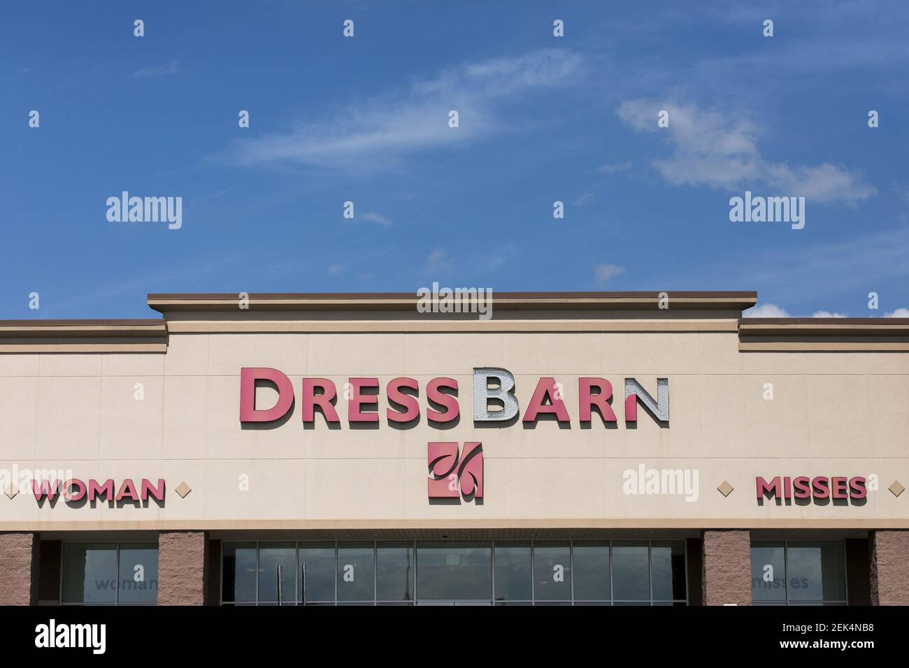 A logo sign outside of a closed and abandoned Dressbarn retail store ...
