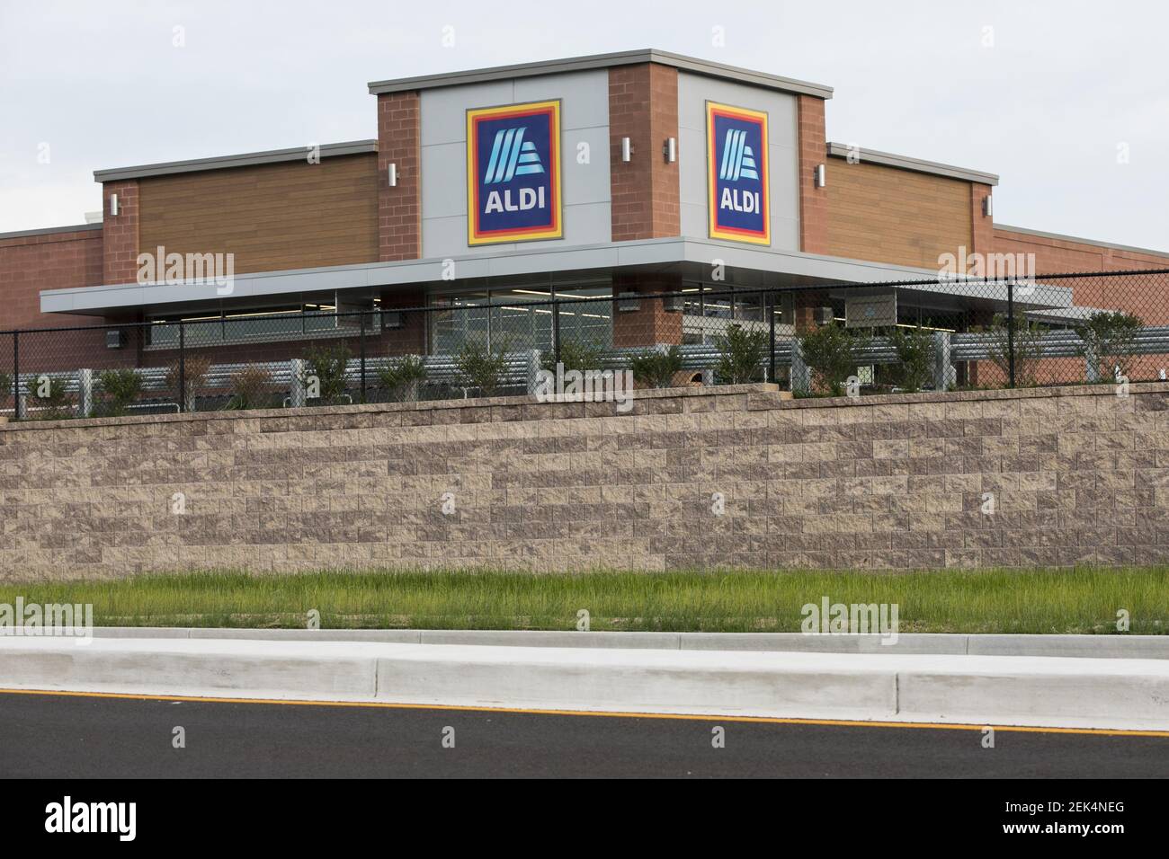 A logo sign outside of a Aldi retail grocery store location in ...