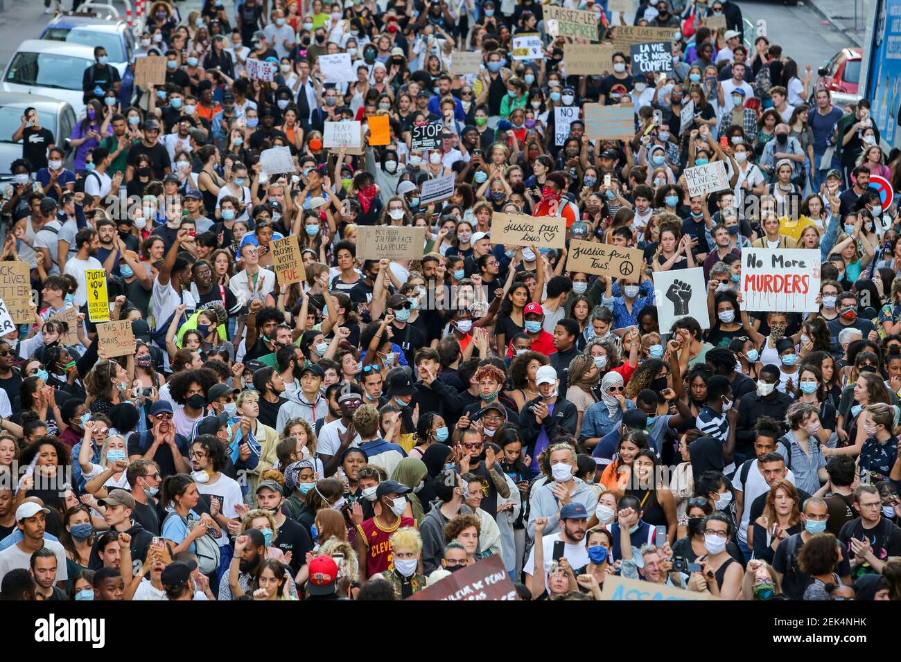Crowd of protesters marching with placards, chanting slogans as they ...