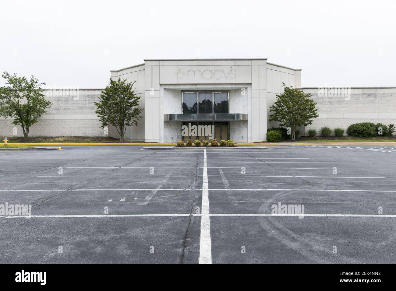 The faded outline of a logo sign outside of a closed and abandoned ...