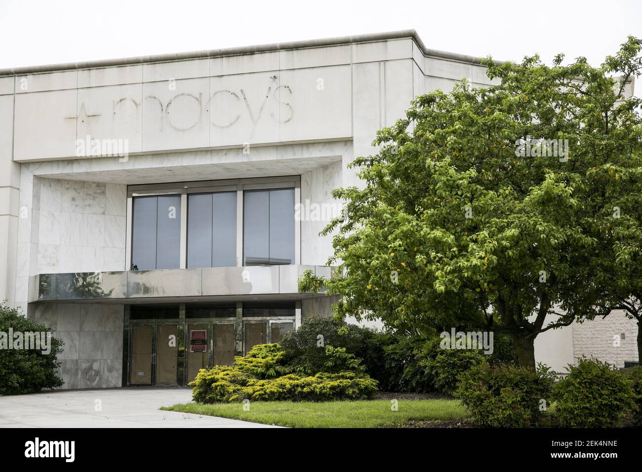 The faded outline of a logo sign outside of a closed and abandoned ...