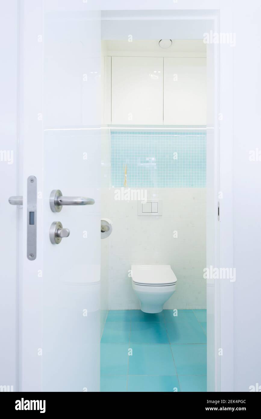 toilet in modern small bathroom in blue and white color combination ...