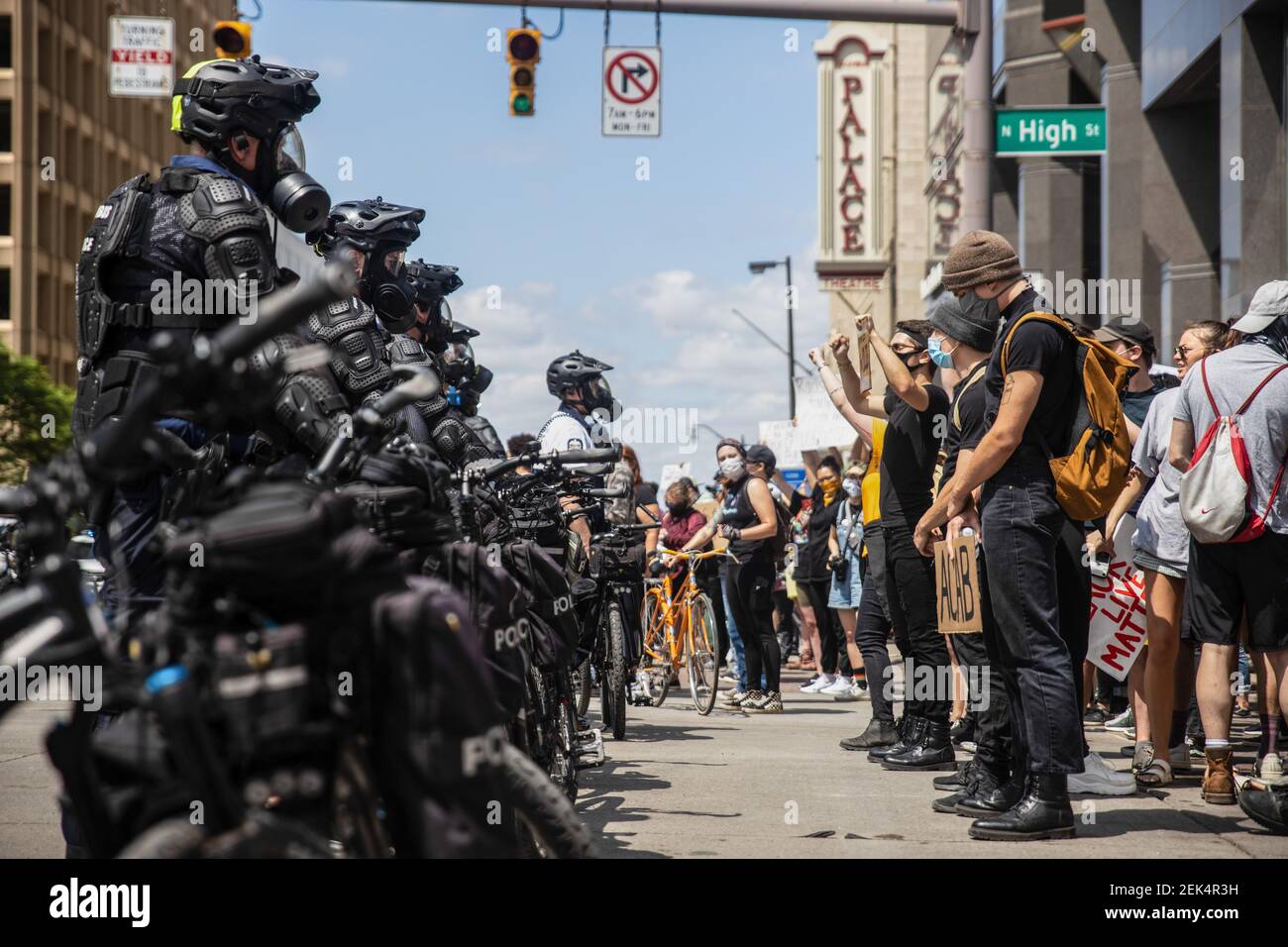Protesters confront police officers standing in the middle of the ...