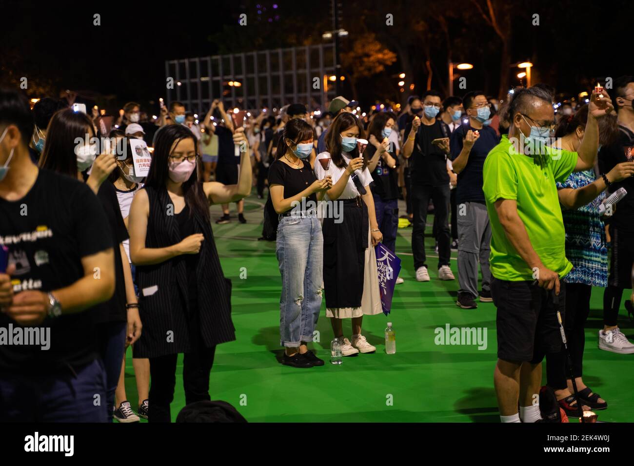 Participants were seen holding up candles in the memorial vigil in ...